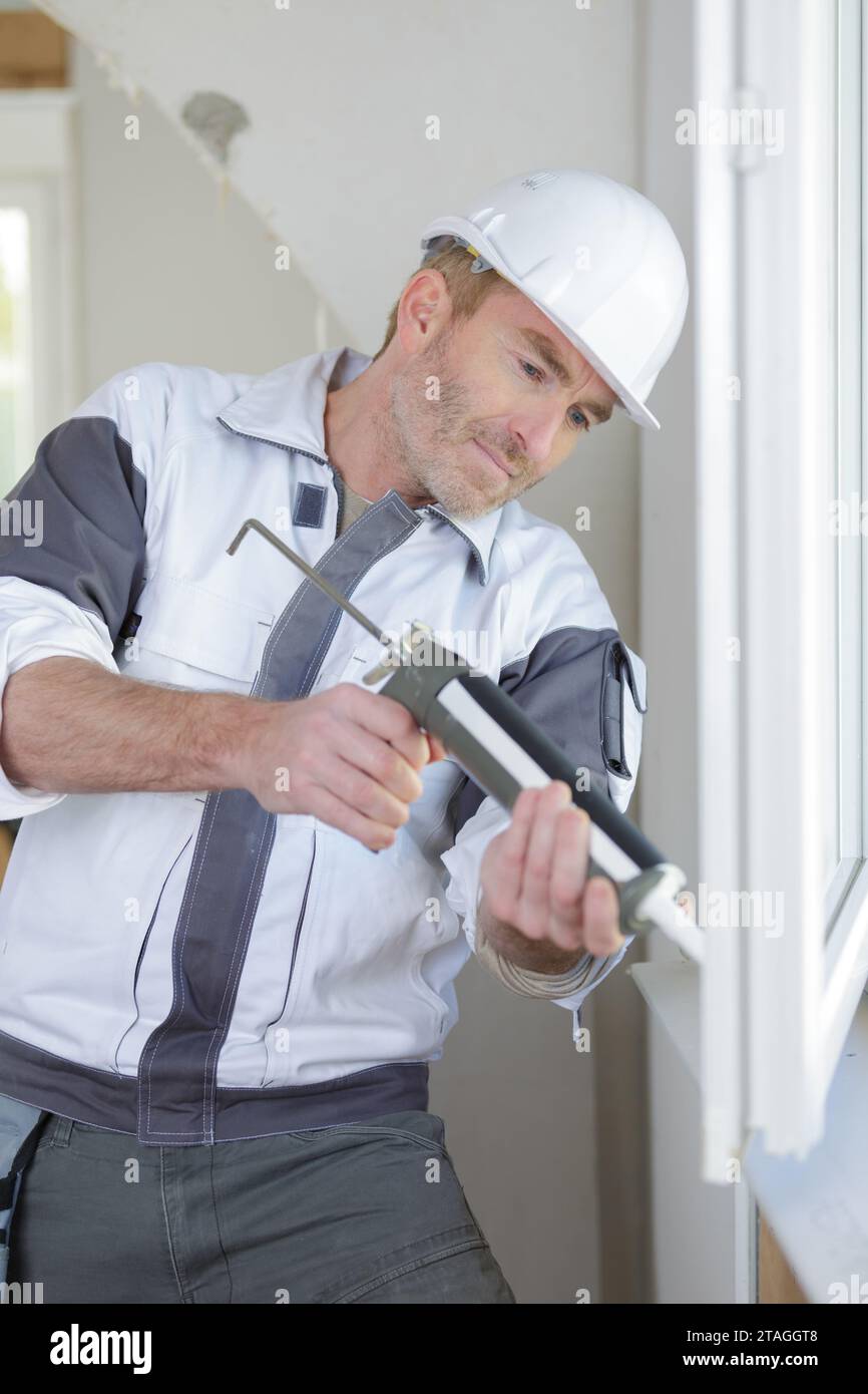 construction worker installing window in house Stock Photo - Alamy