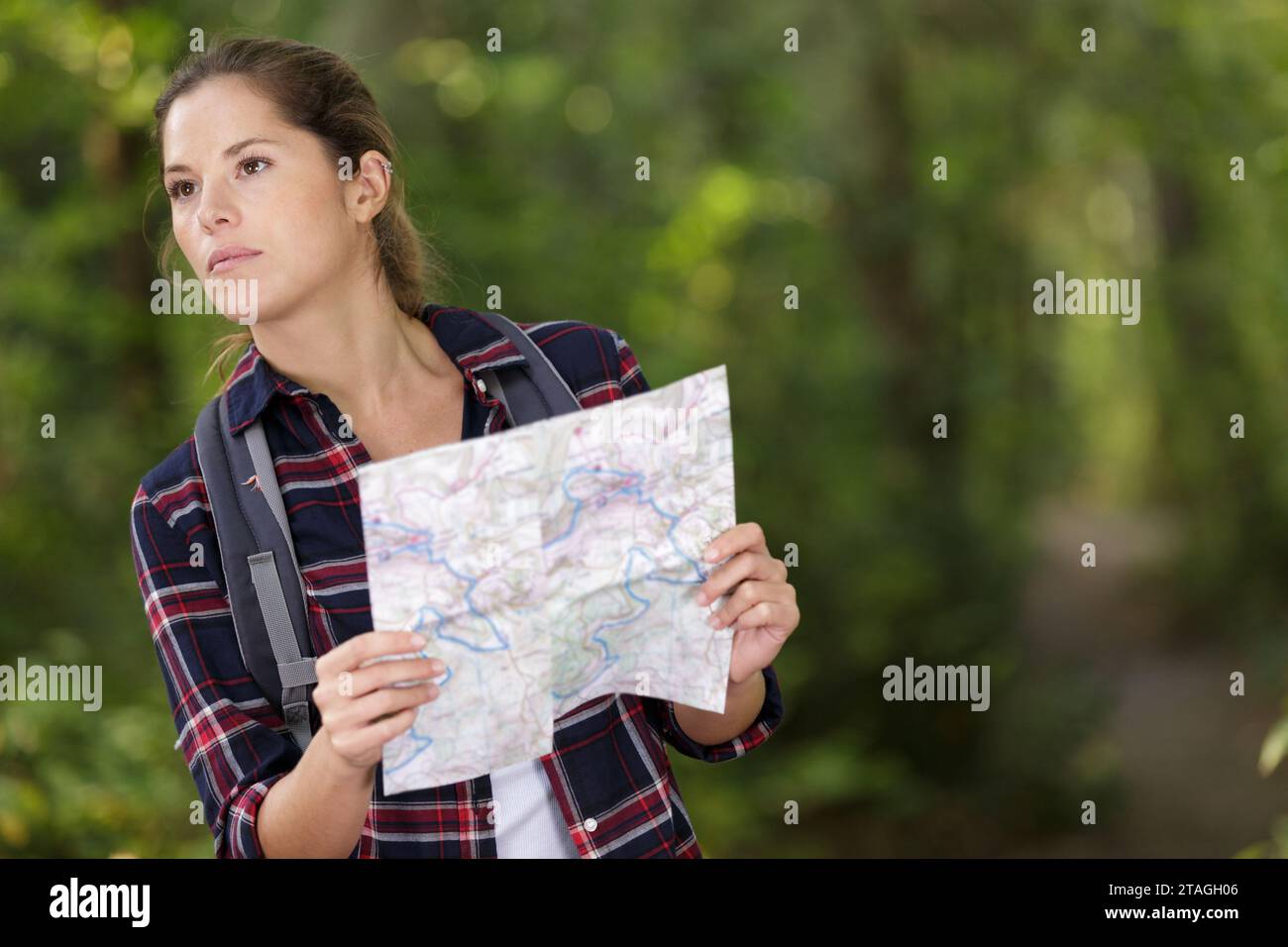travel woman reading map among trees at forest Stock Photo - Alamy
