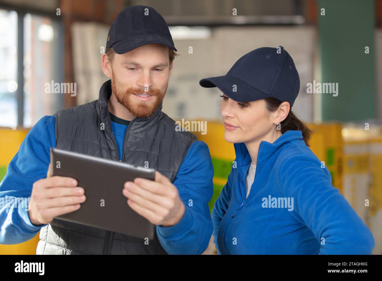 male and female builders using tablet in construction site Stock Photo ...