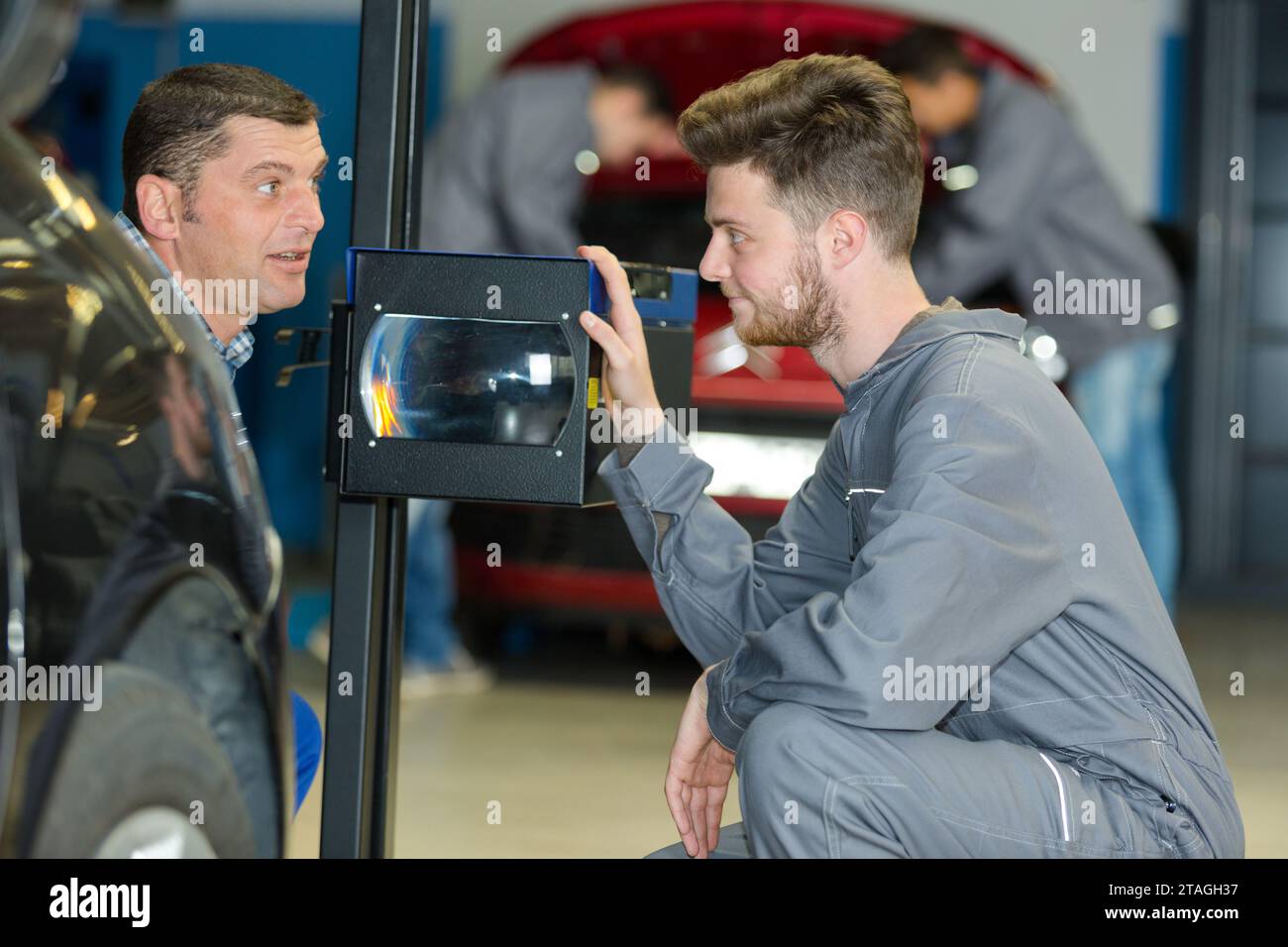 mechanics doing a headlight testing Stock Photo - Alamy