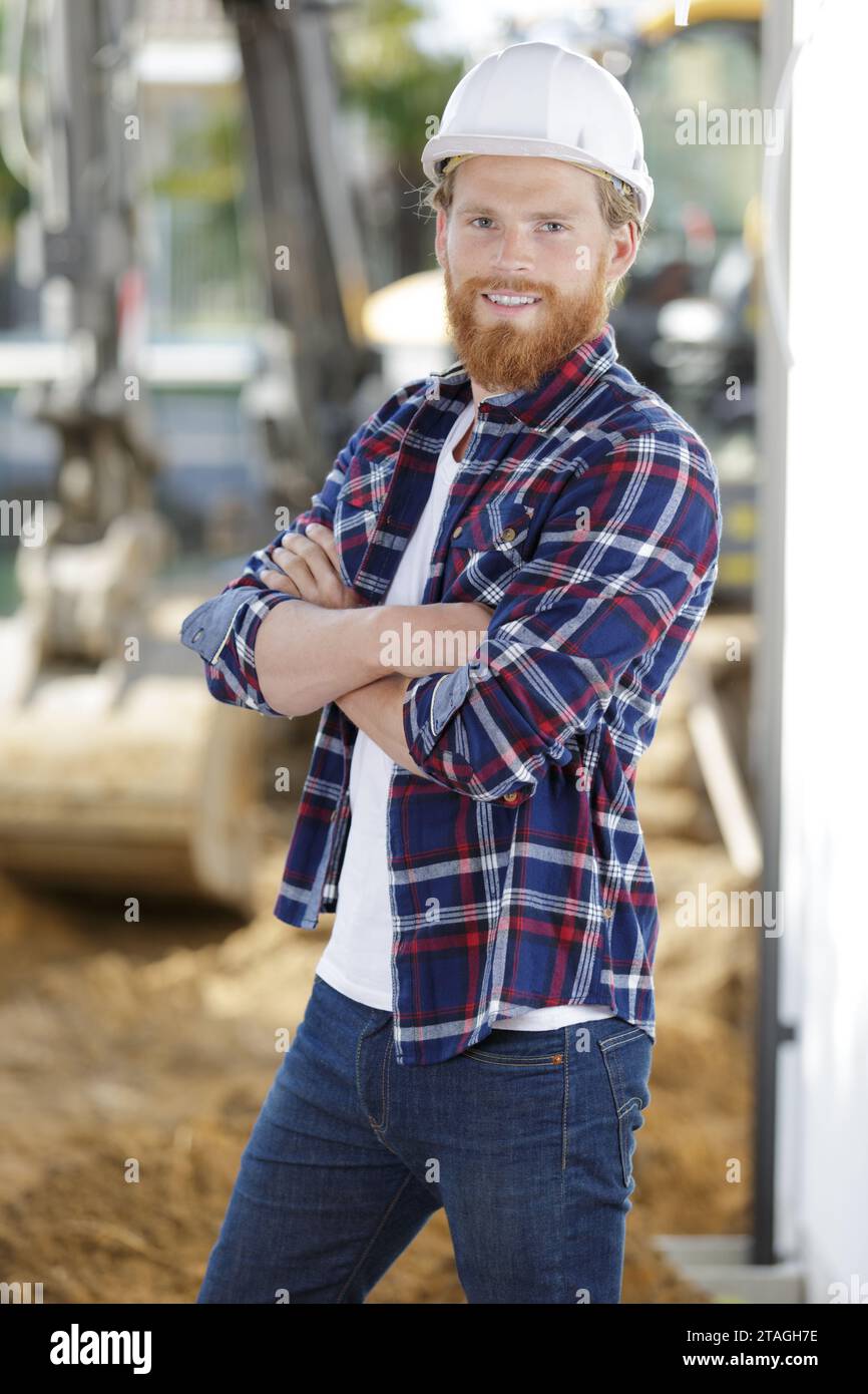 construction worker on site with arms crossed Stock Photo - Alamy