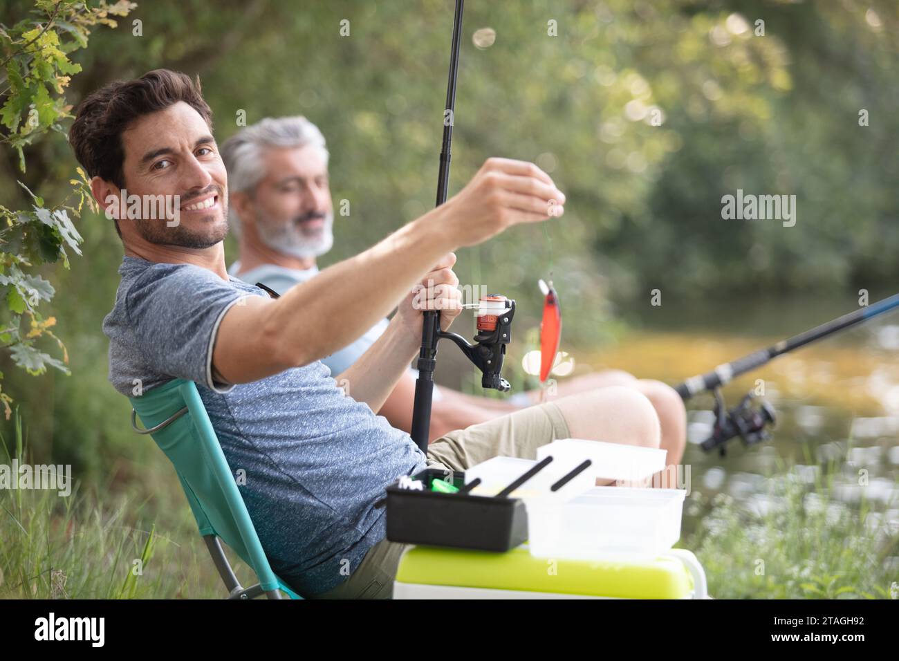 two friends are fishing together Stock Photo - Alamy