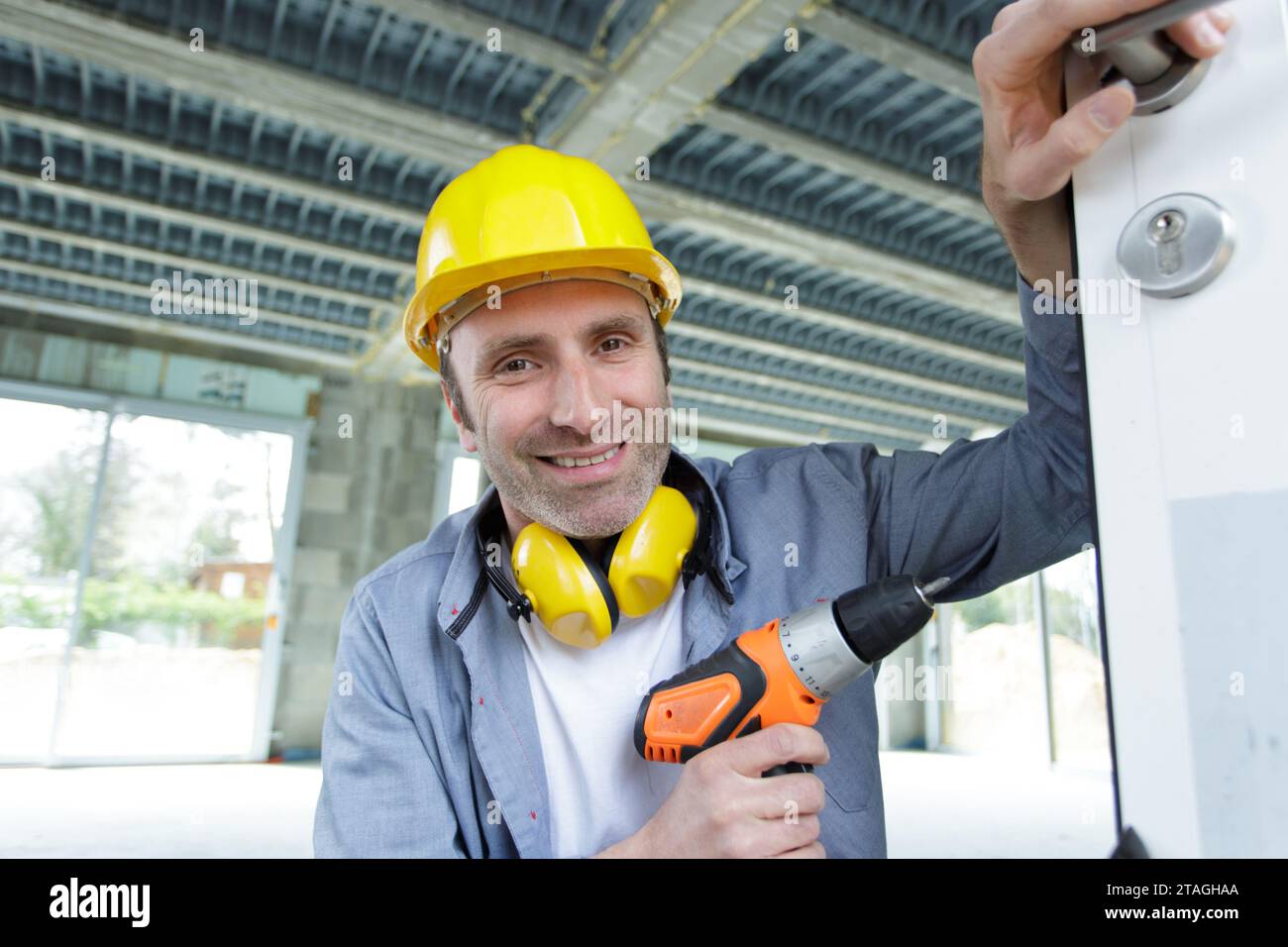 happy builder smiling at the camera Stock Photo - Alamy