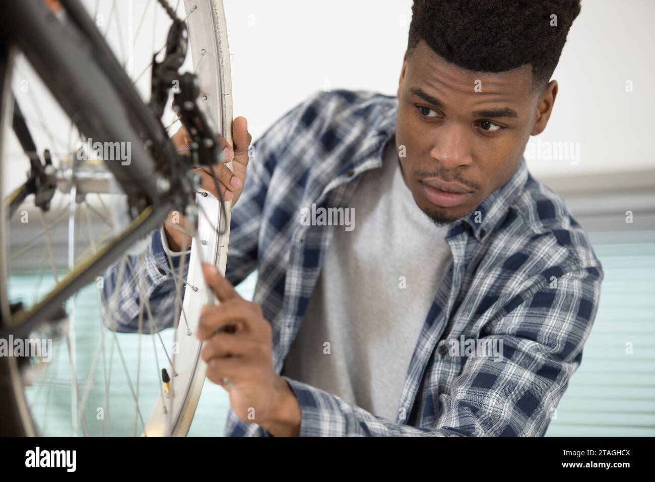 Man reparing bicycle hi-res stock photography and images - Alamy