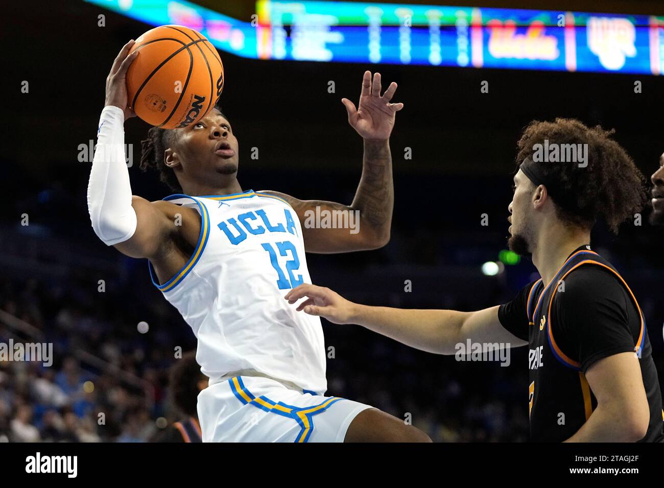 UCLA guard Sebastian Mack, left, shoots as UC Riverside guard Isaiah ...