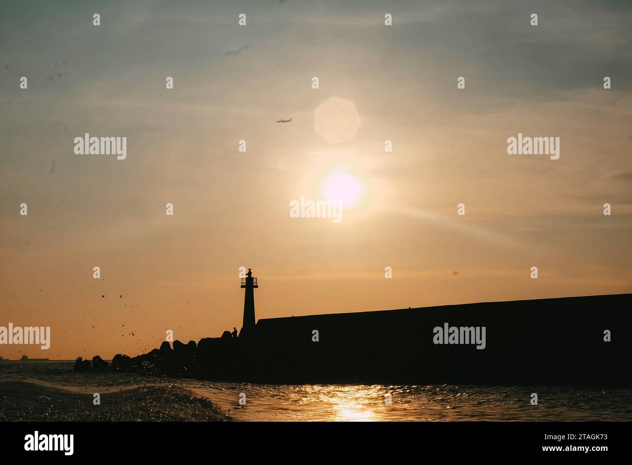 Sunset on the highest lighthouse. Low angle view of silhouette of ...