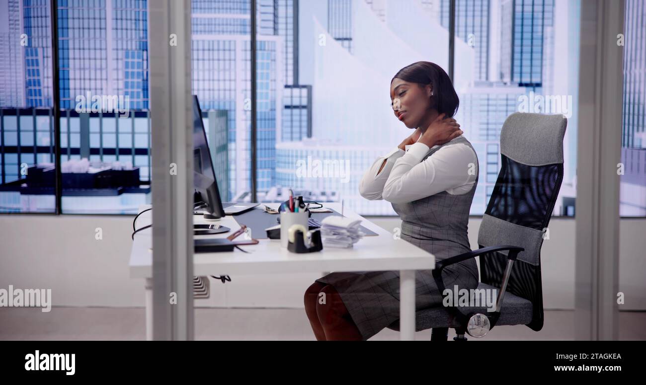 Improving Office Ergonomics: Woman Corrects Bad Posture Stock Photo - Alamy