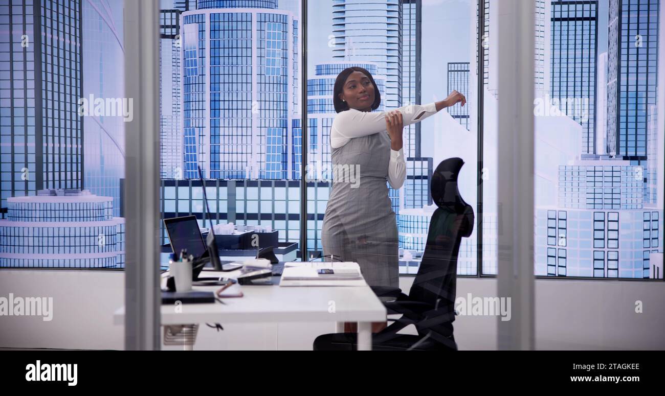 Standing Lady at Office Desk Exercising with Stretch Stock Photo - Alamy