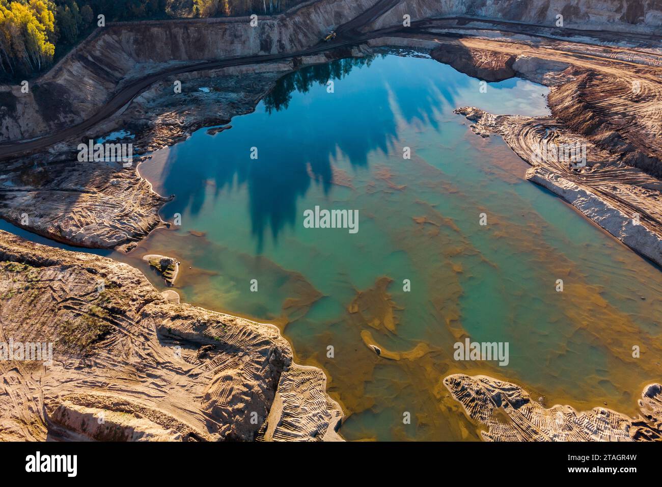 View from above of the sand quarry territory with a picturesque pond ...
