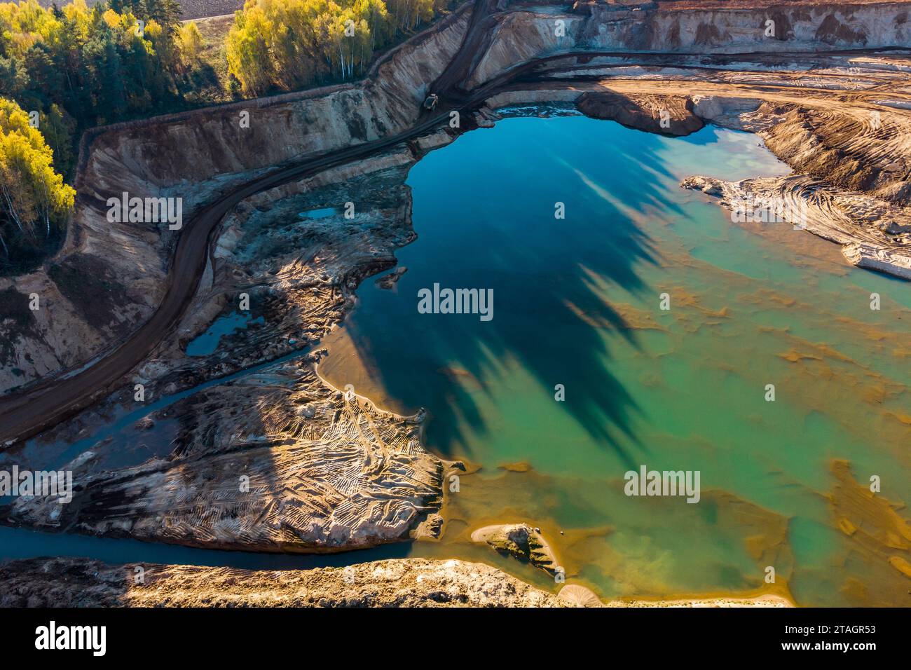 View from above of the sand quarry territory with a picturesque pond ...