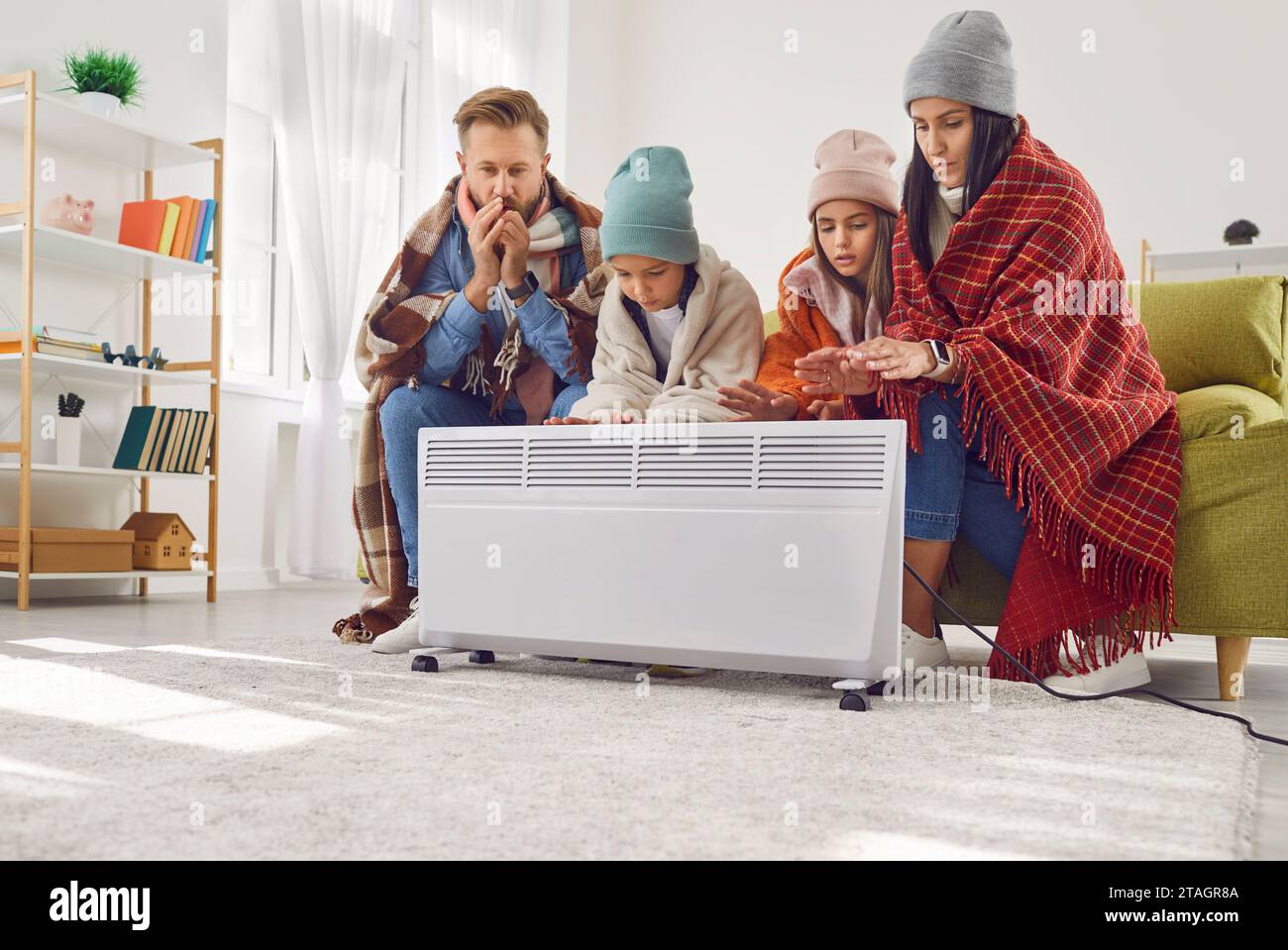 Family with children getting cold at home in winter and sitting by ...