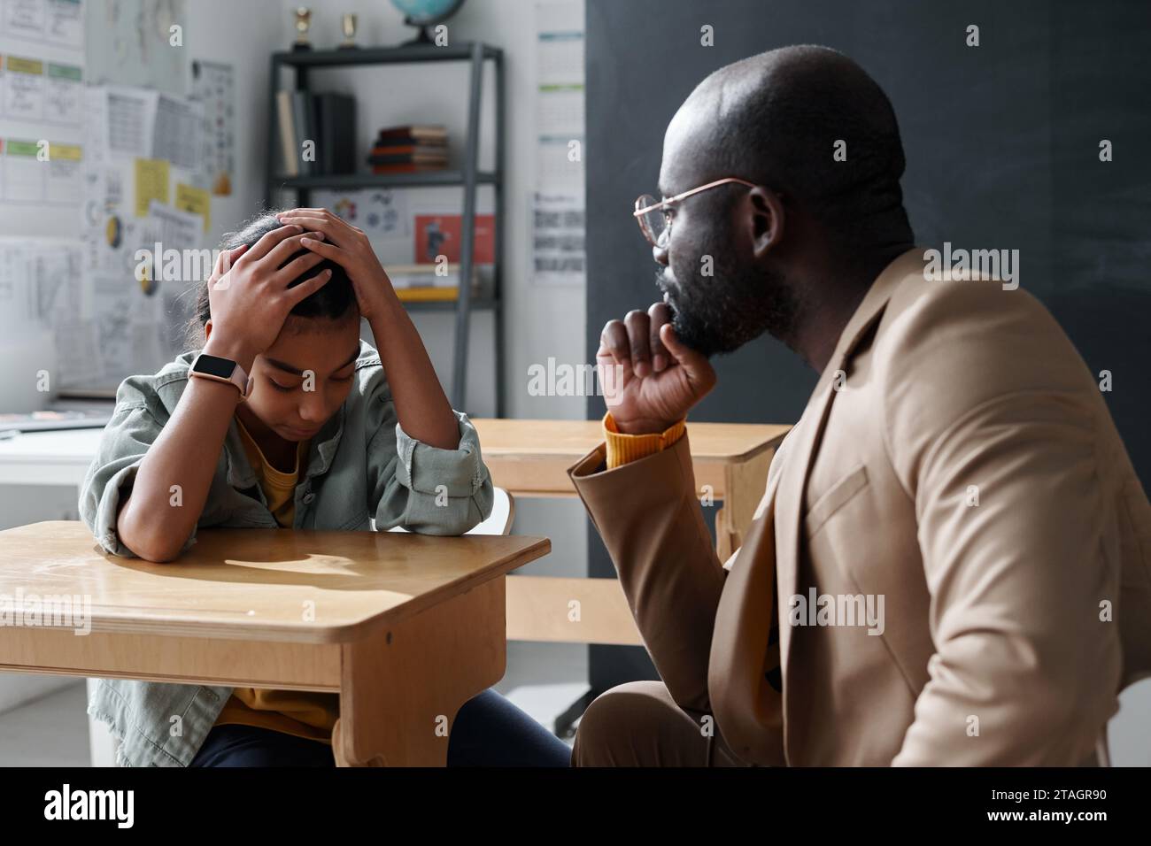 African American teacher having a serious conversation with difficult ...
