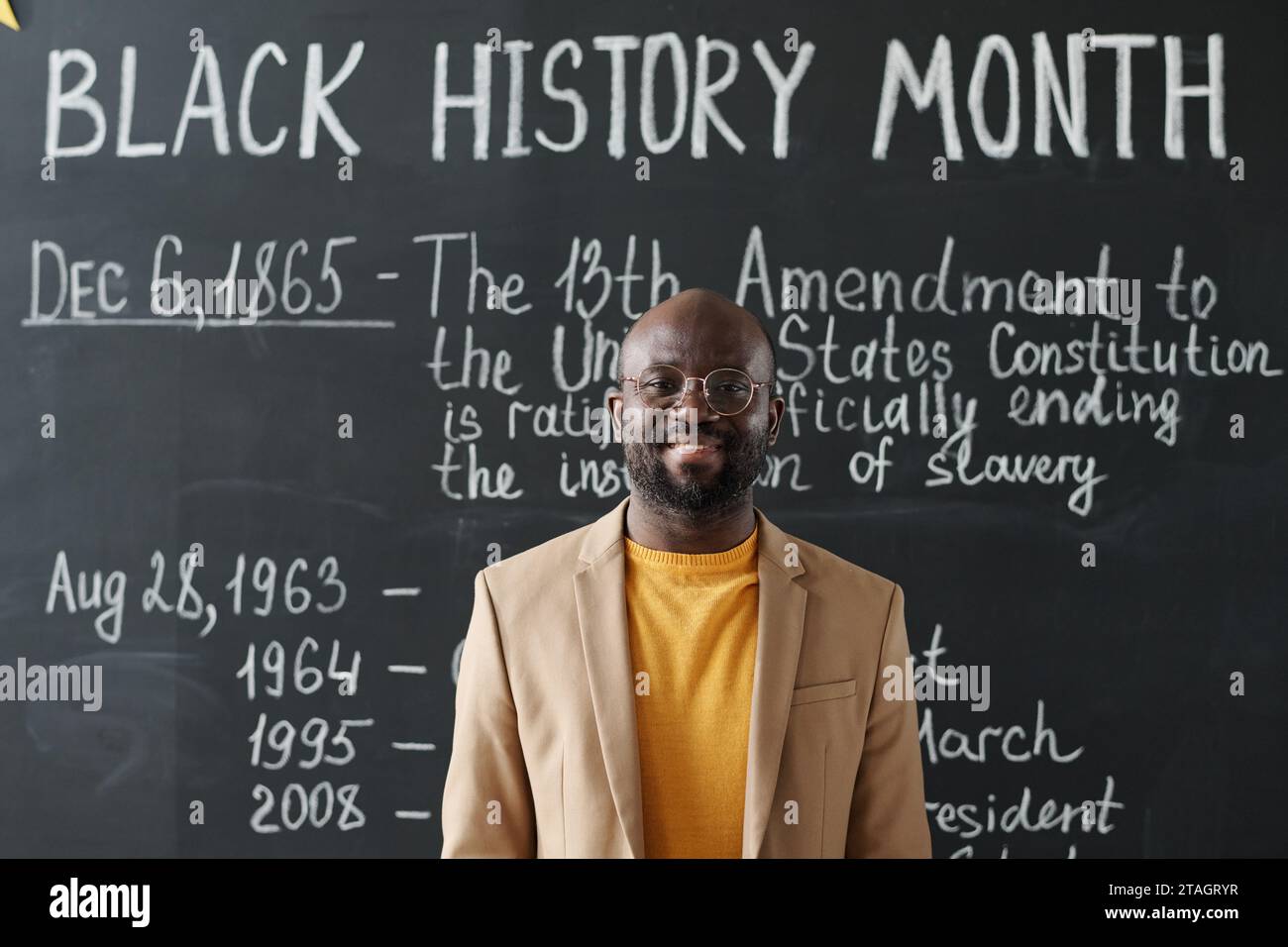 Portrait of history African American teacher smiling at camera standing ...