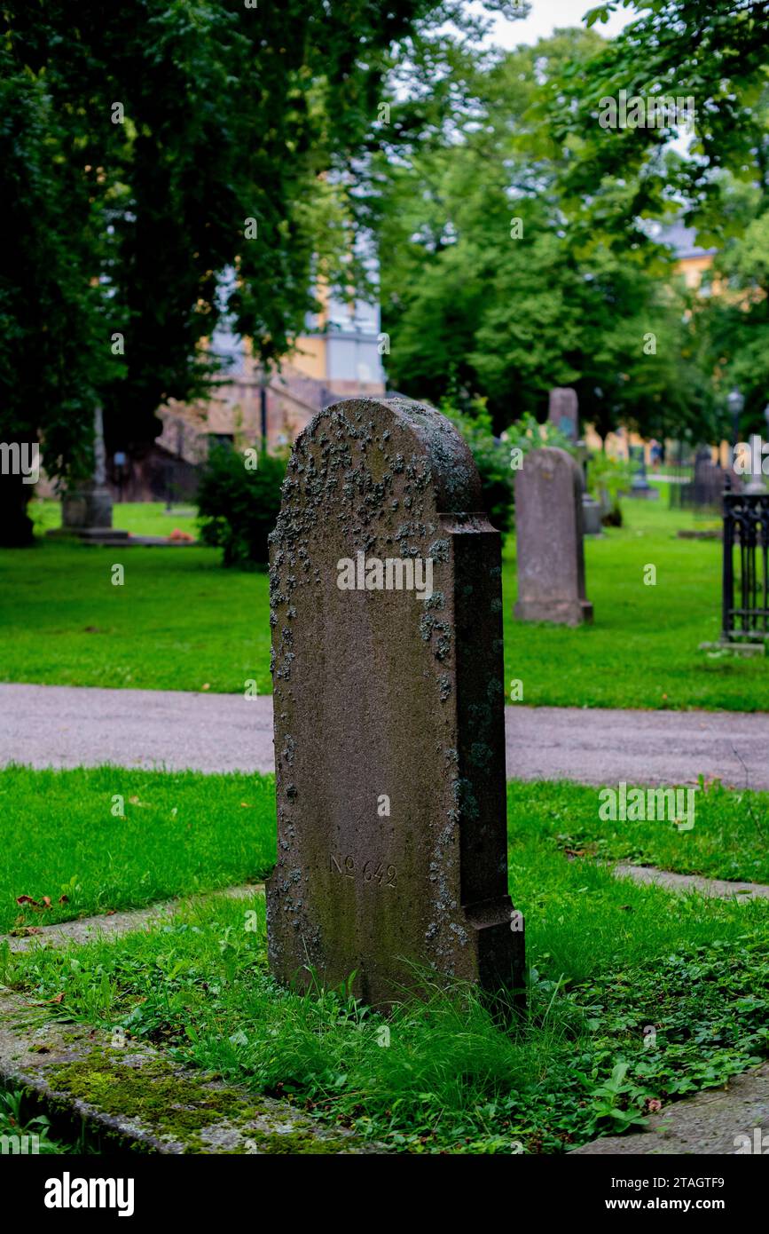An outdoor cemetery with a lush, green landscape Stock Photo - Alamy
