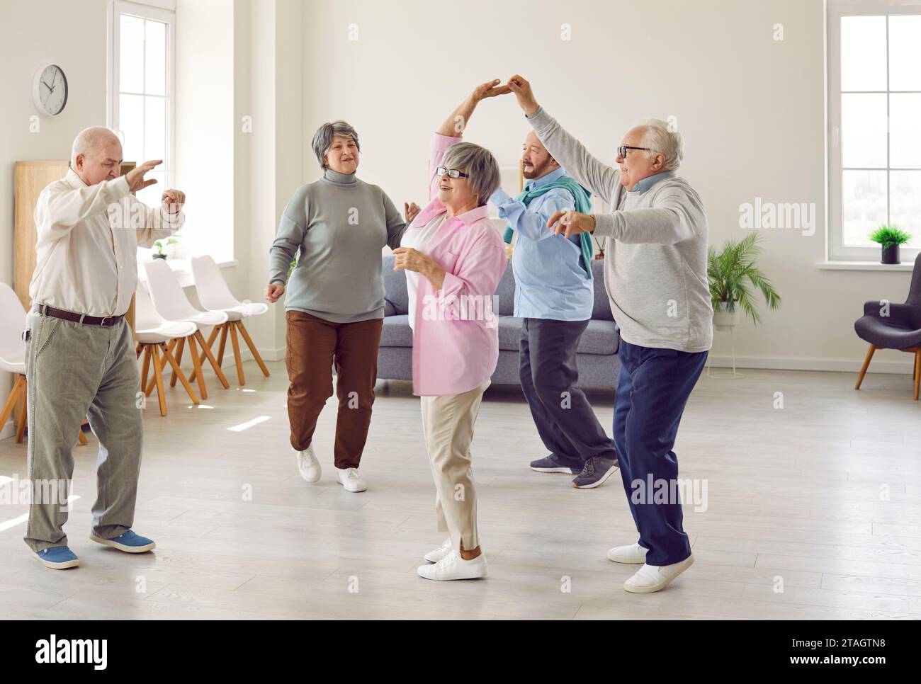 Elderly men and women actively spend time having fun and dancing at ...
