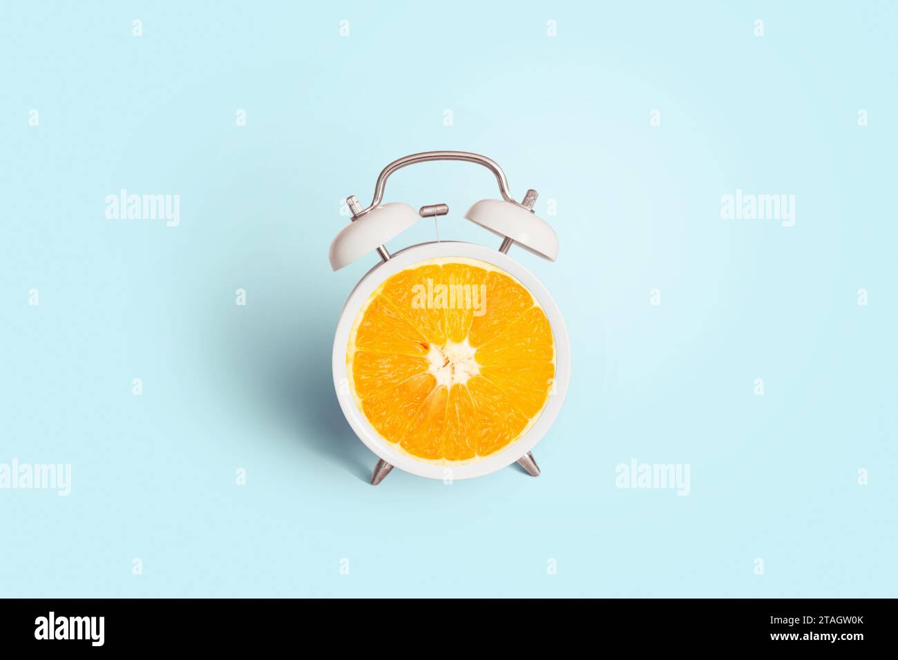 Creative vintage orange clock on a blue background, concept. Marketing ...