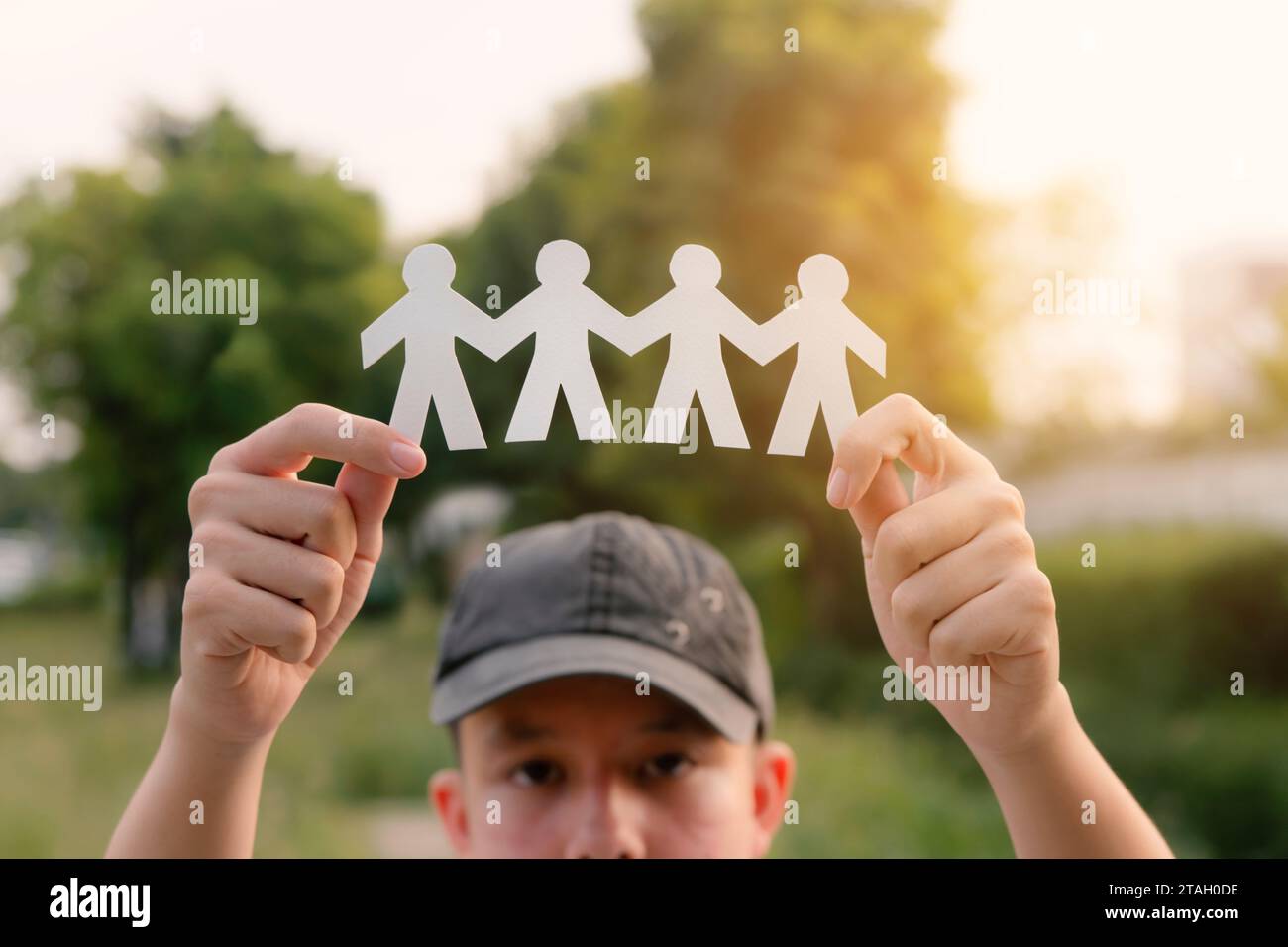 Teamwork and relations. symbolic of paper chains in teenage boy hand ...