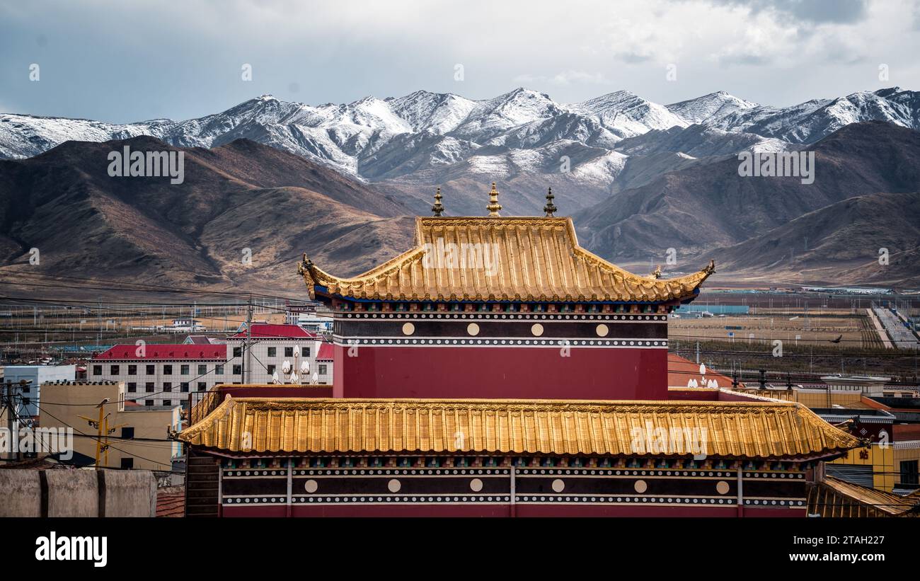 A majestic view of vast snow-capped mountains looming over the Tibetan ...