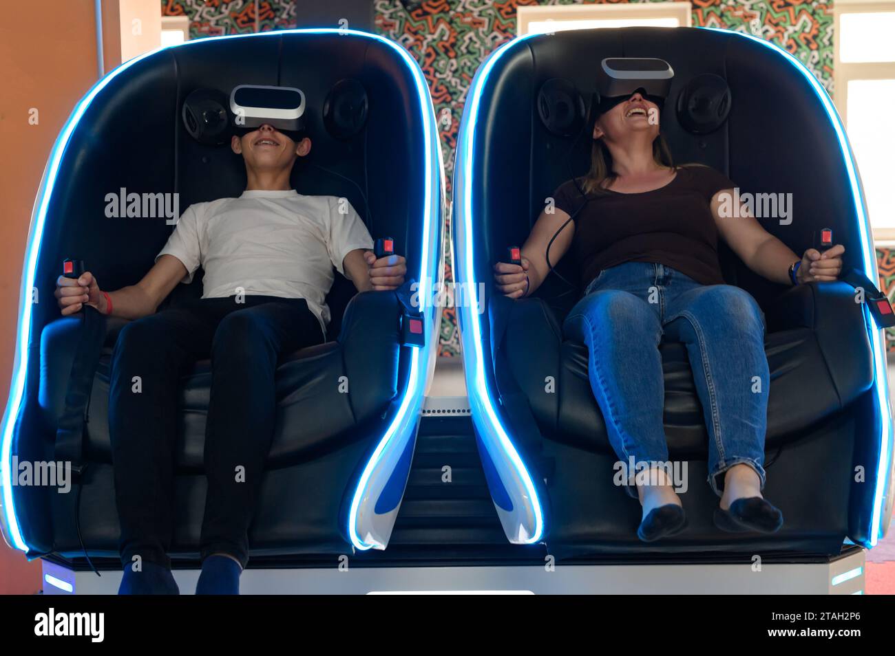 Virtual reality attraction, son and mother experience adrenaline from ...