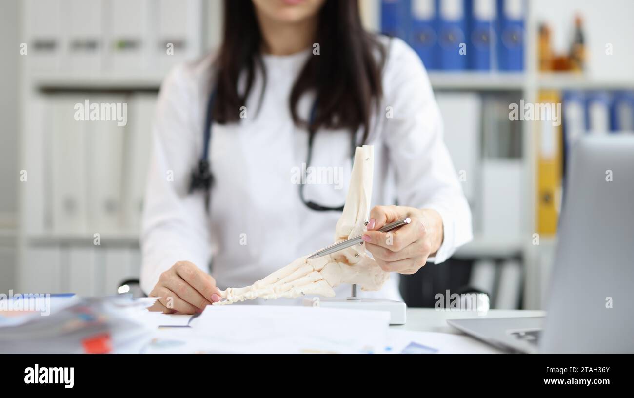 Orthopedic doctor explains physiology of bone model by pointing to ...