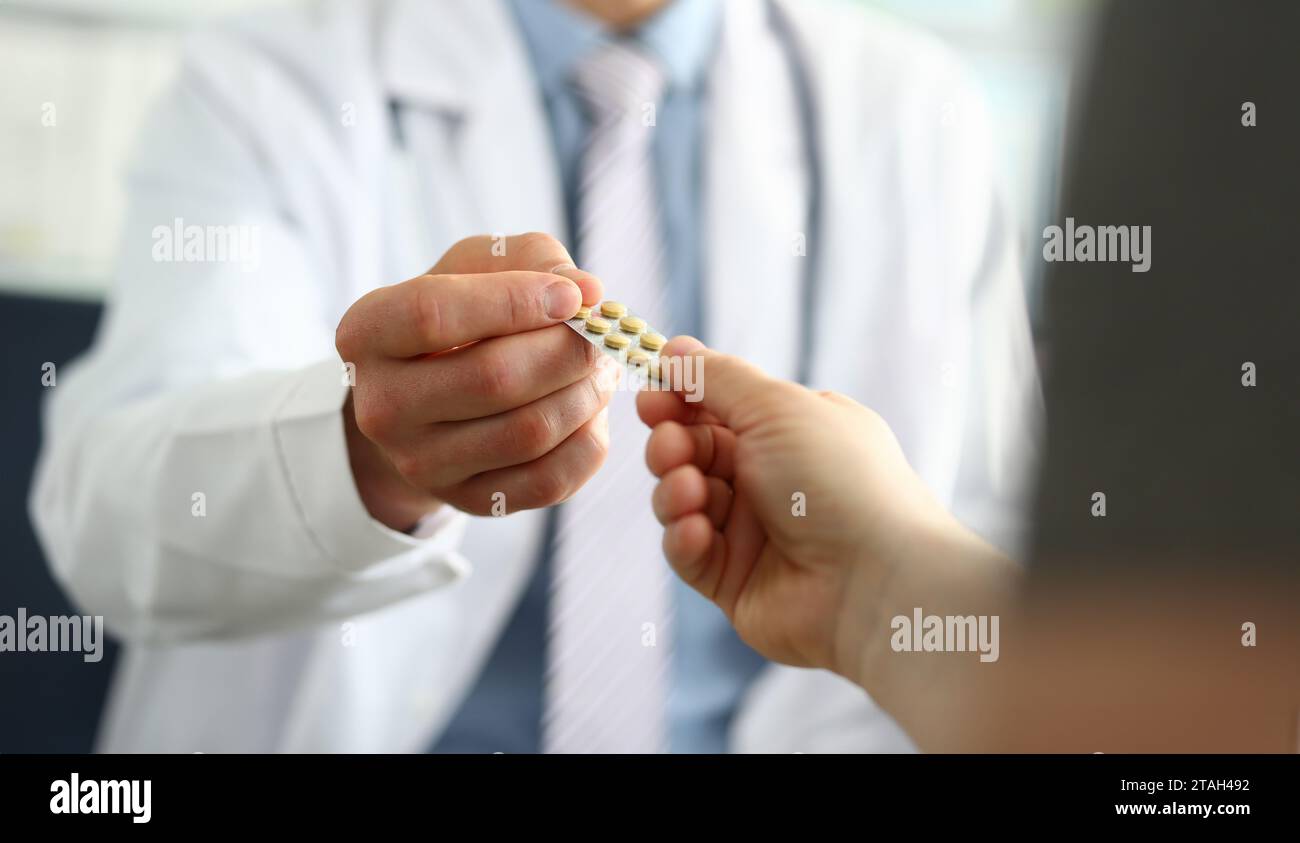 Doctor giving medications pills hi-res stock photography and images - Alamy