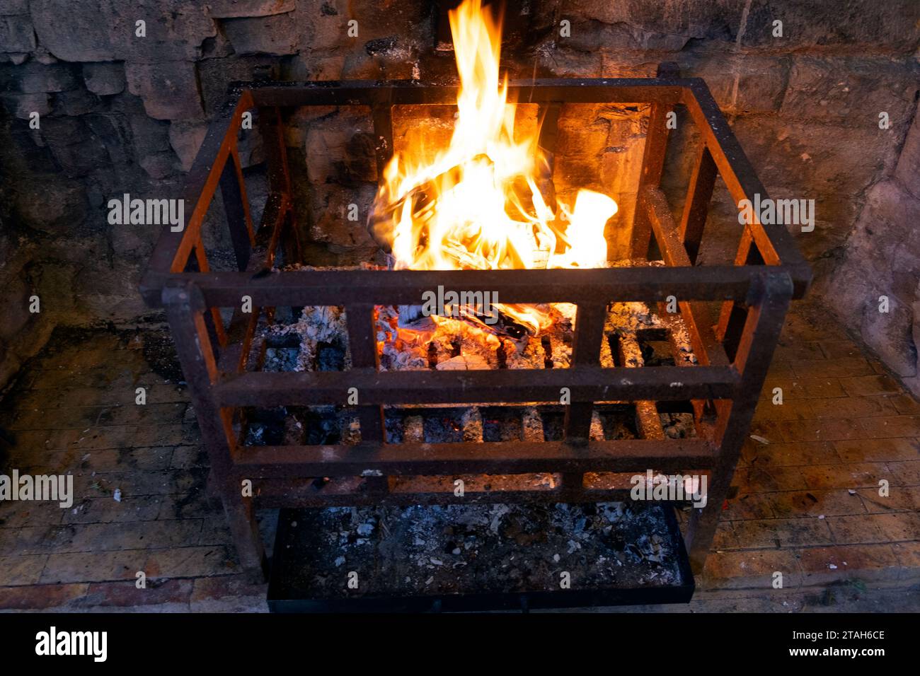 Glowing flames of fire burning in iron grate at Hay Castle at Christmas ...