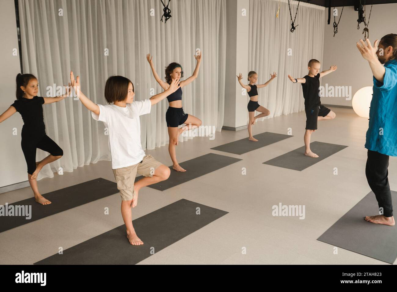 Children do yoga in the gym under the guidance of an instructor ...