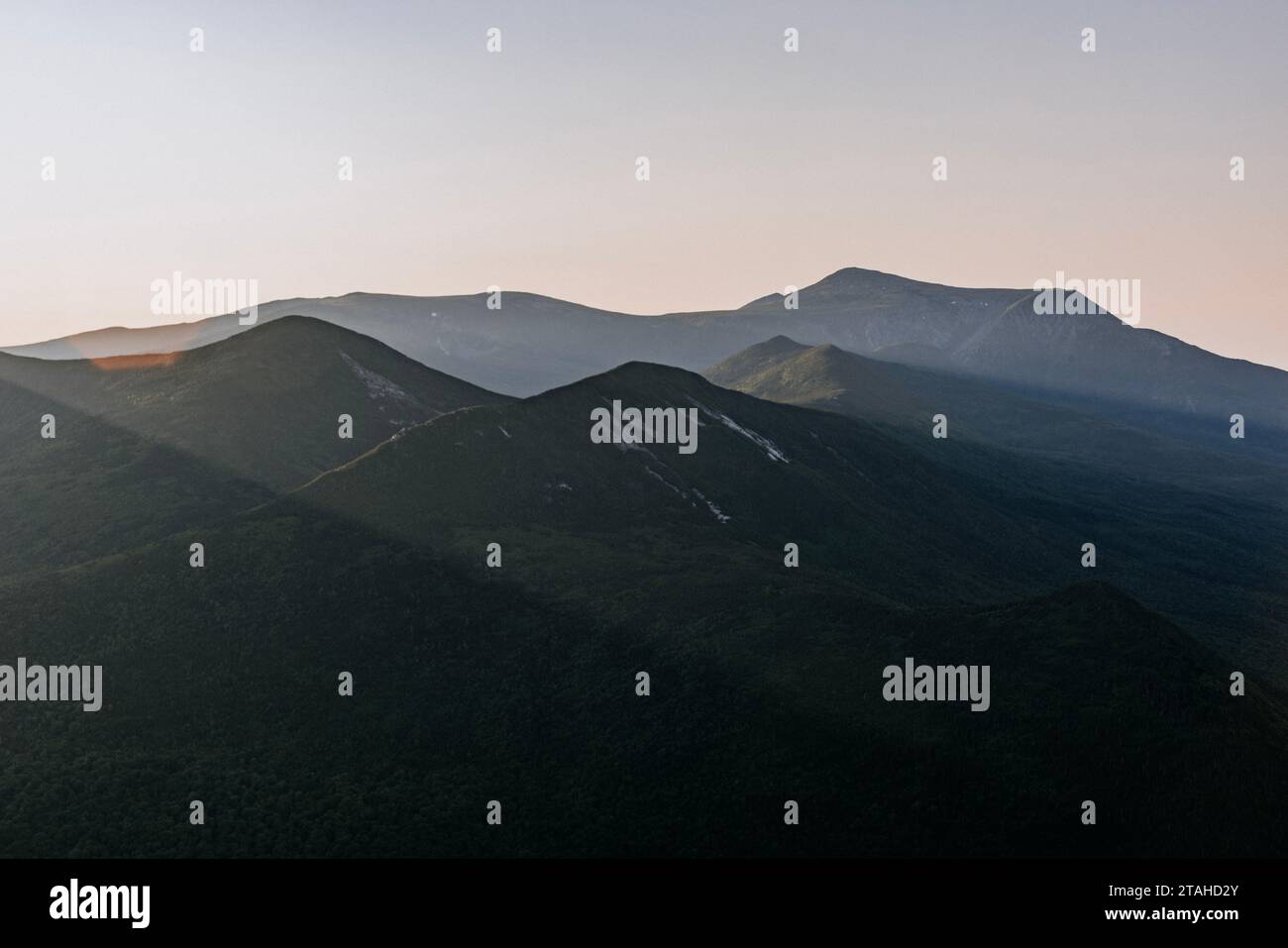 Rays of sunshine at sunrise over Mount Katahdin, Maine Stock Photo - Alamy