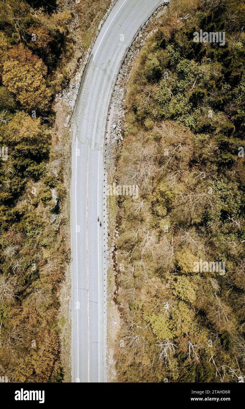 Aerial view of two cyclists riding up a mountain pass in Vermont Stock ...
