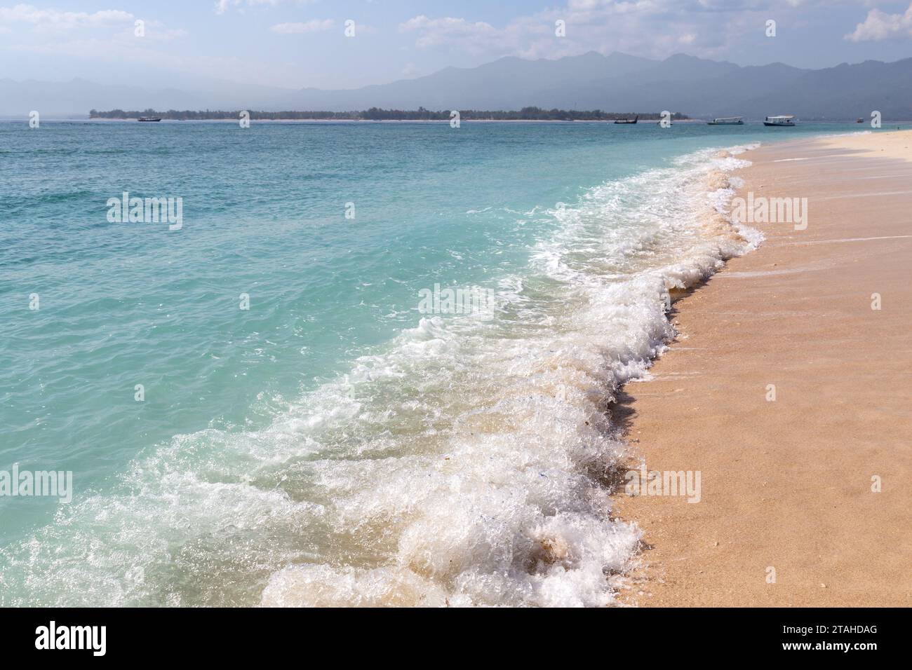 Empty white sandy beach with clear waters, Gili Islands, Indonesia ...