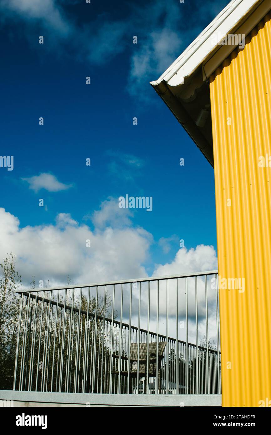 Yellow side of building with bright blue sunny sky Stock Photo - Alamy