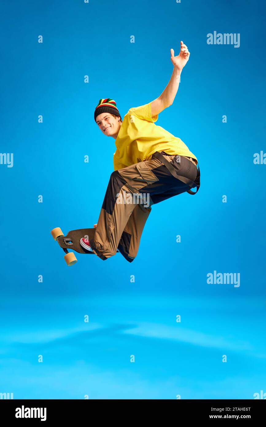 Positive, smiling man wearing in rastaman, reggie style doing Ollie ...