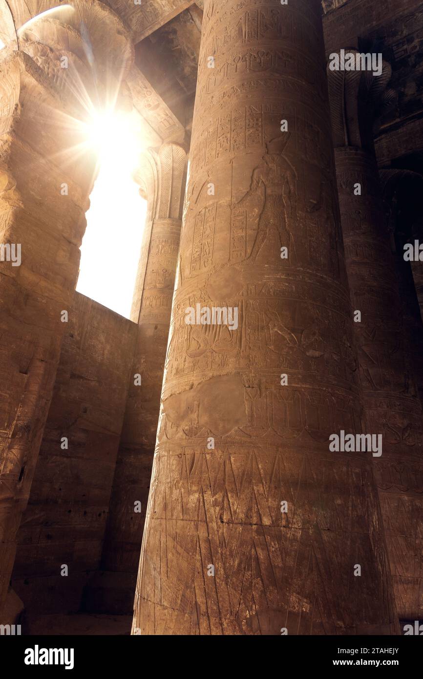 Golden sunbeam hitting column covered with egyptian hieroglyphs Stock ...