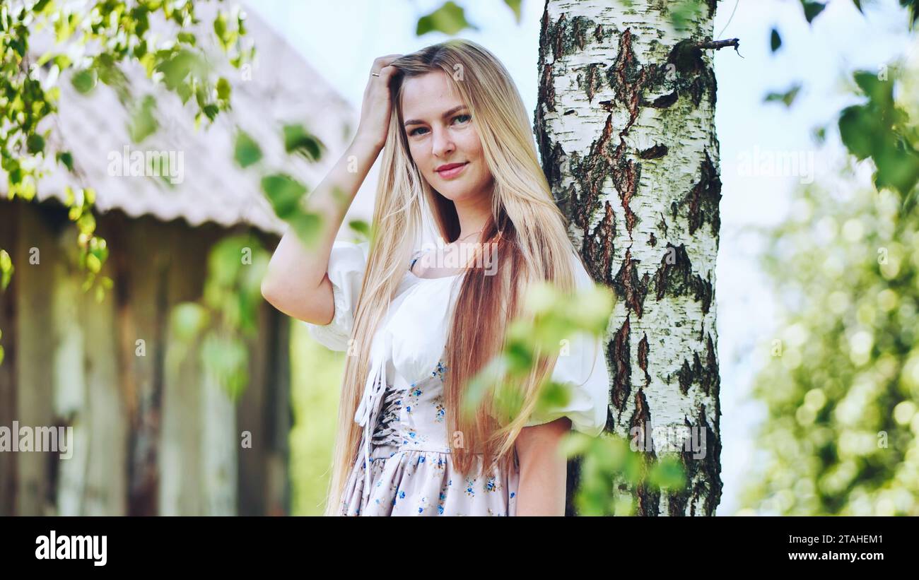 German girl posing by the birch tree Stock Photo - Alamy