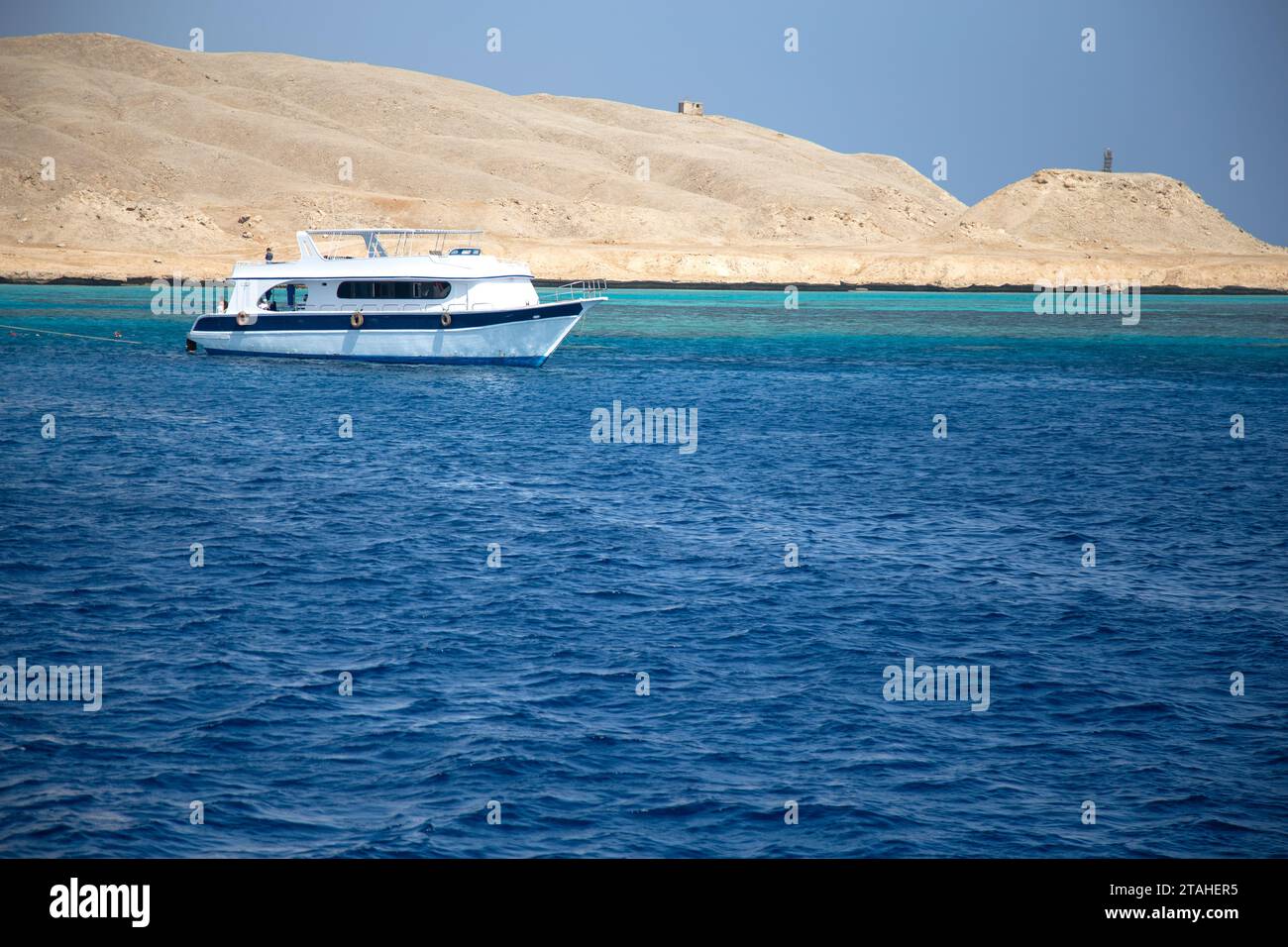 Small diving boat cruising blue water of the Red Sea, Hurghada, Egypt ...