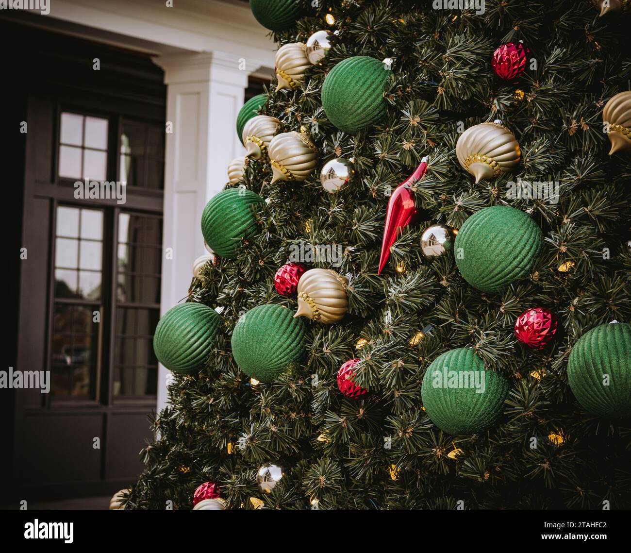 Outdoor Decorated Red and Green christmas Tree Stock Photo - Alamy