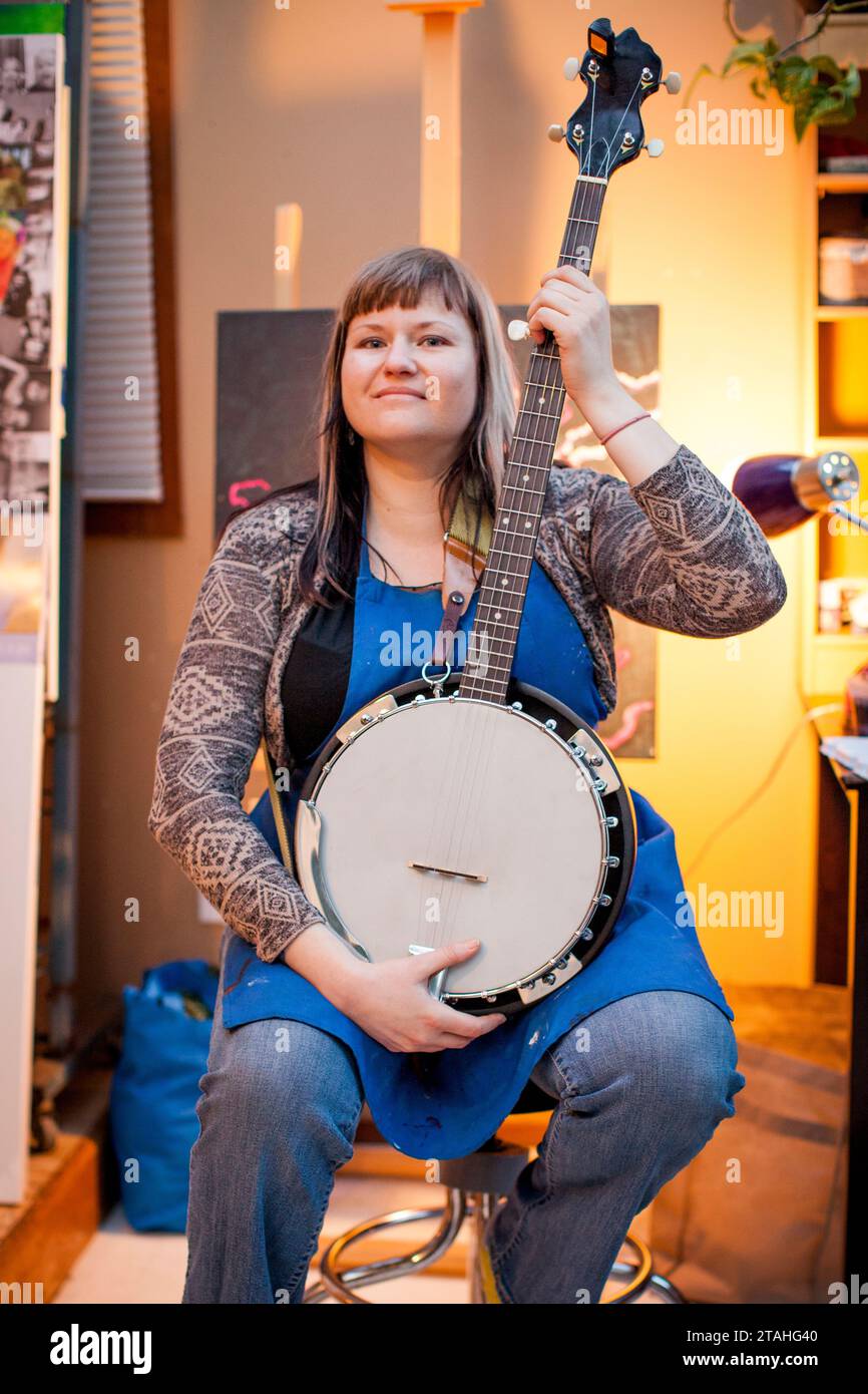 Female Artist in Blue Apron, Portrait with Banjo Stock Photo - Alamy