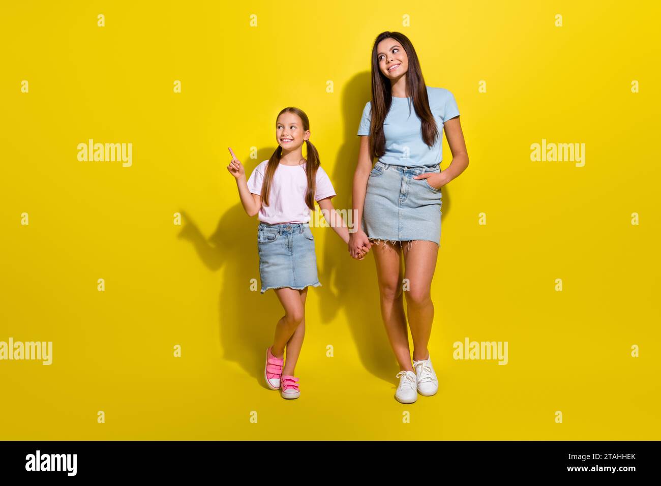 Full length photo of cute shiny small siblings dressed t-shirts walking ...
