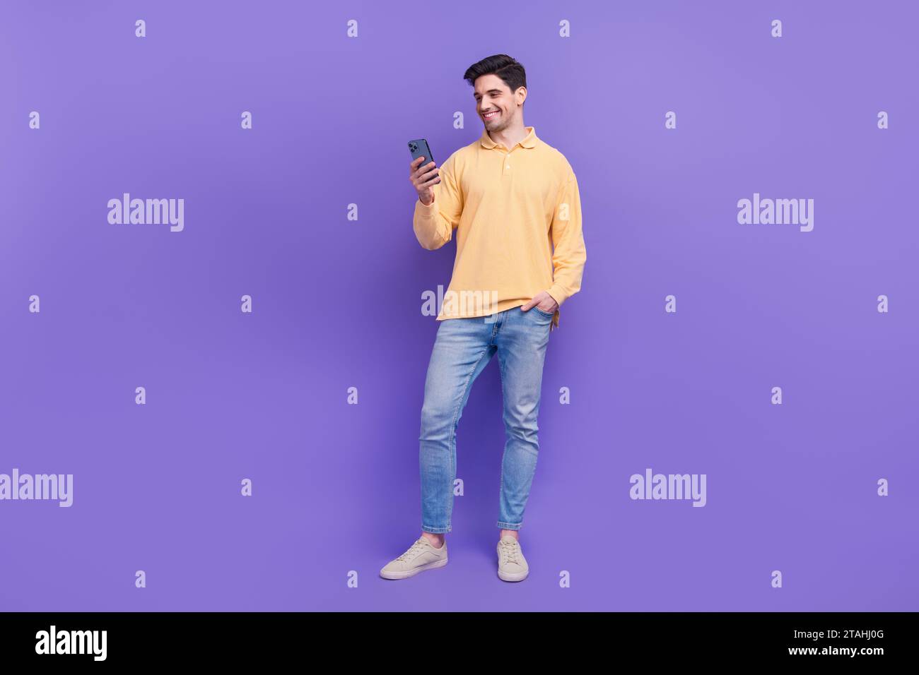 Full length photo of handsome young guy hold device comment post wear ...