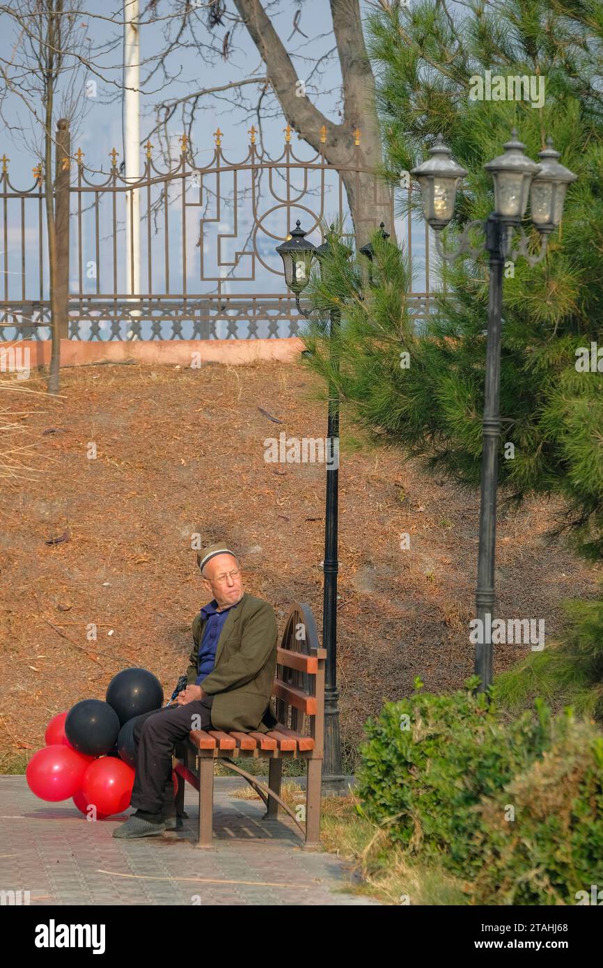 Khujand, Tajikistan - November 28, 2023:A man with balloons in his hand ...