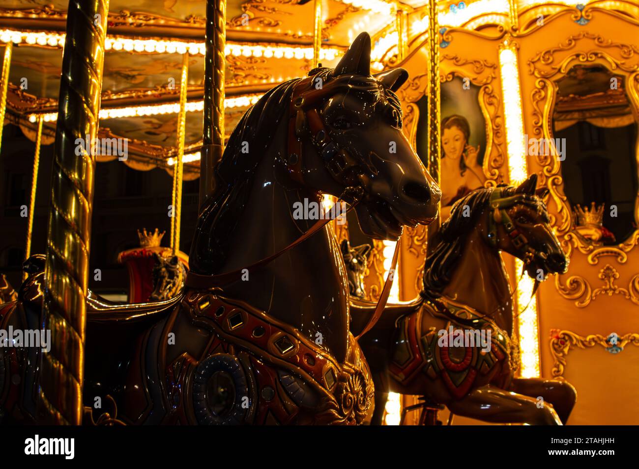 Black carousel horse. Carousel at night Stock Photo - Alamy