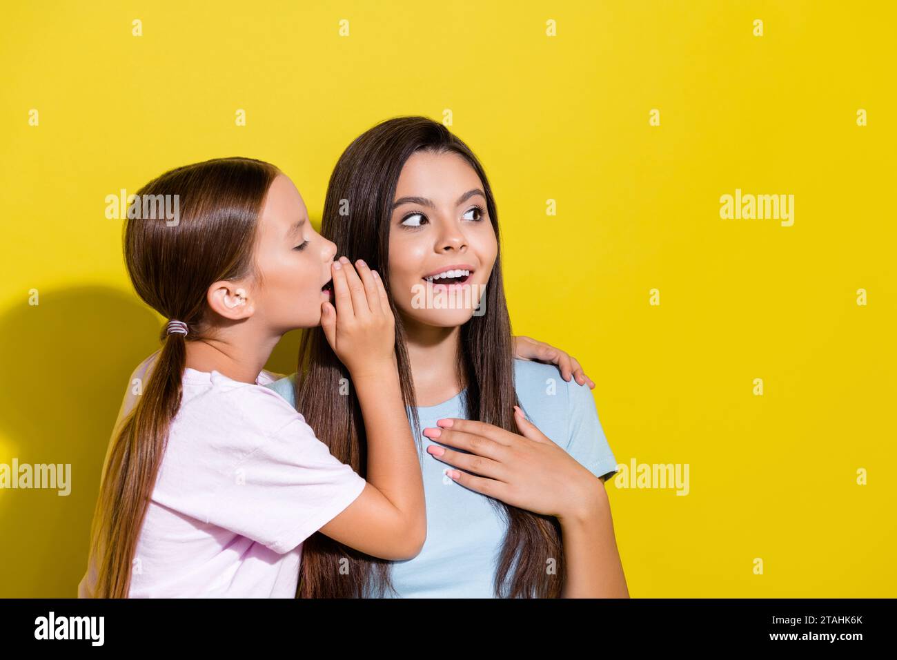 Photo of adorable cheerful small siblings dressed t-shirts telling ...