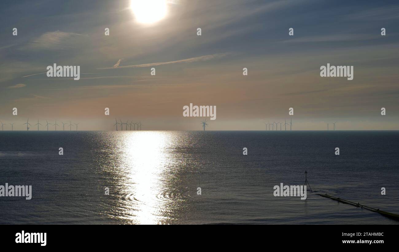 View of an offshore wind farm on the horizon in the distance off the ...