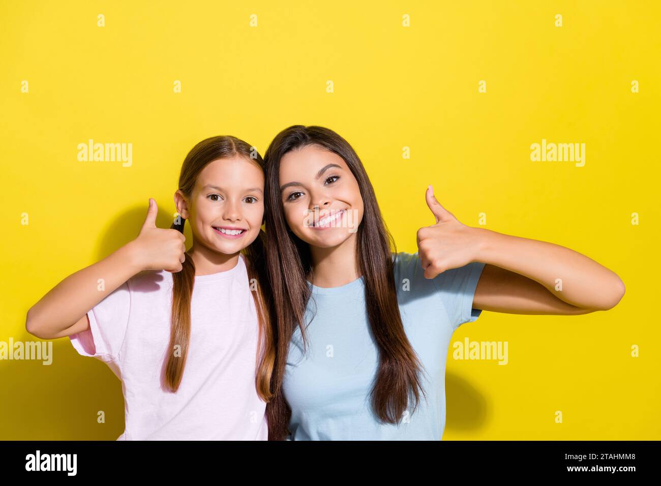 Photo of confident pretty small siblings dressed t-shirts hugging ...