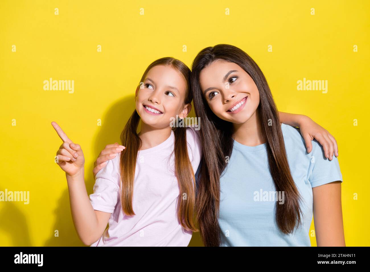 Photo of charming dreamy small siblings dressed t-shirts embracing ...
