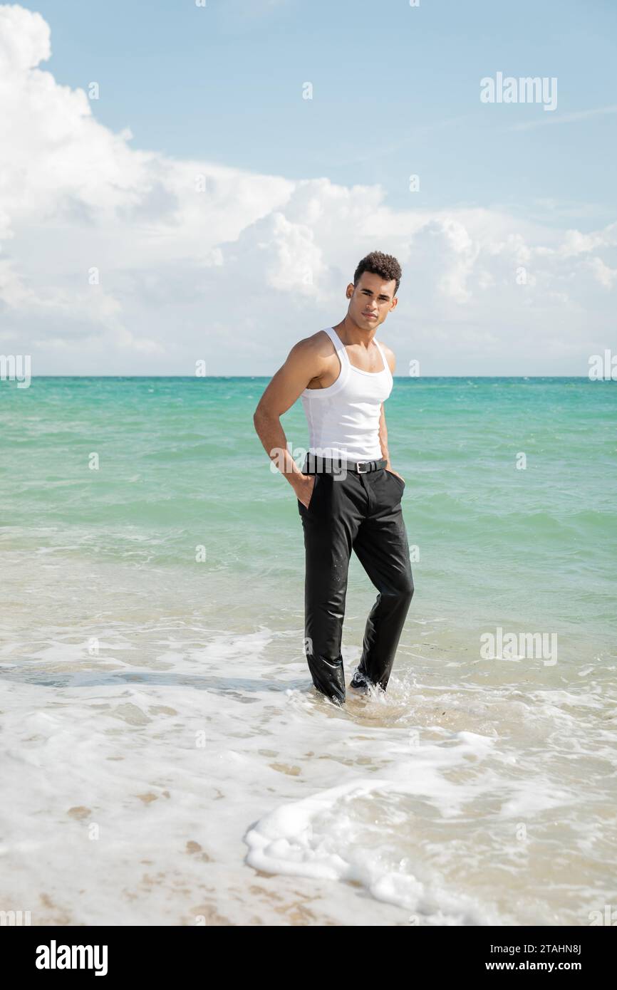 muscular young Cuban man standing in ocean water in Miami South Beach ...