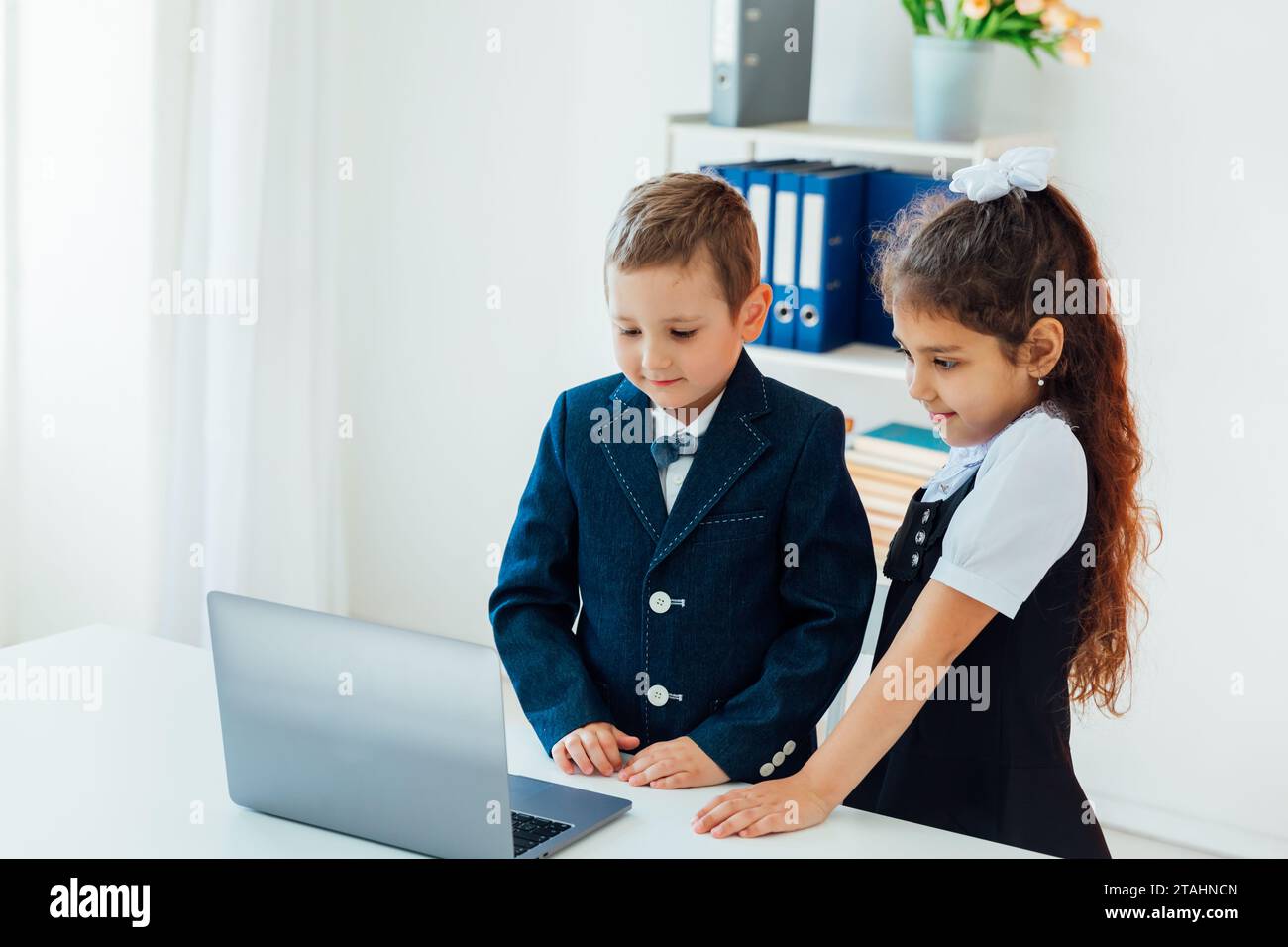Boy and girl studying at the computer online at school Stock Photo - Alamy
