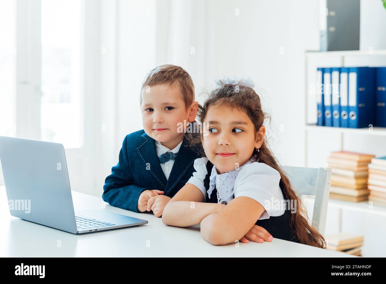 Boy and girl studying at the computer online at school Stock Photo - Alamy