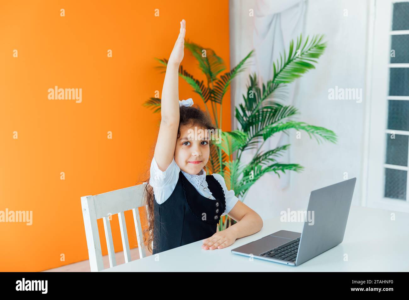Little girl raising her hand up for answer at lesson at school Stock ...