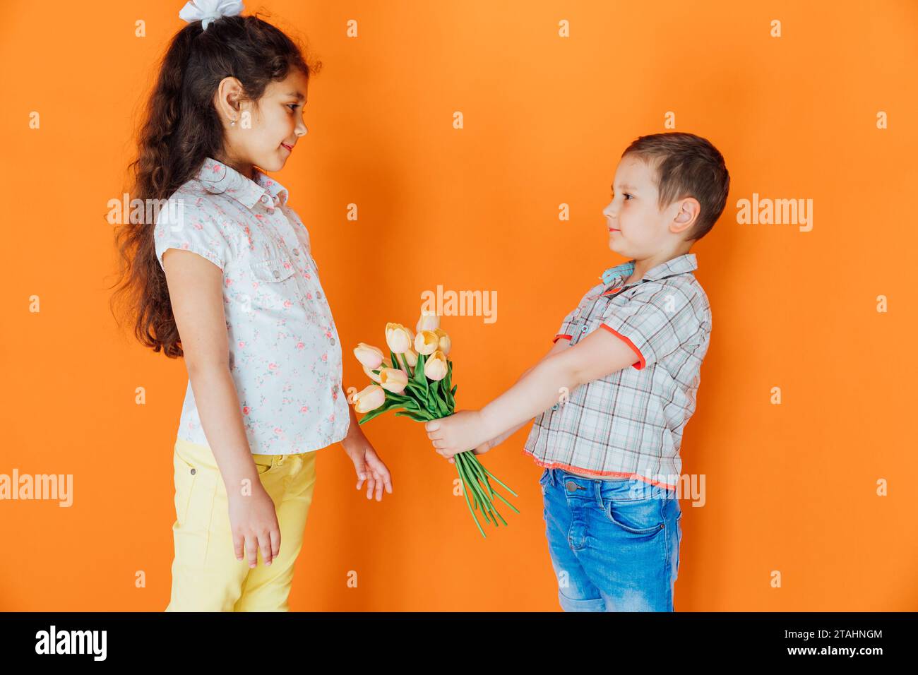 Little boy giving flowers to a girl Stock Photo - Alamy